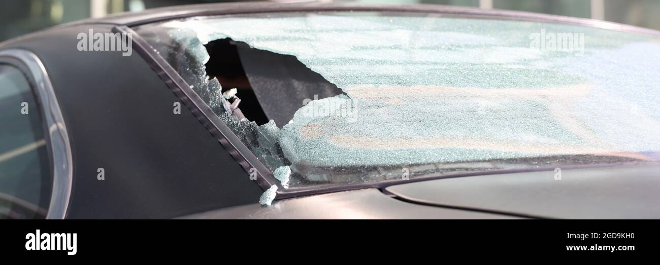 Closeup of hole in rear window of car Stock Photo - Alamy