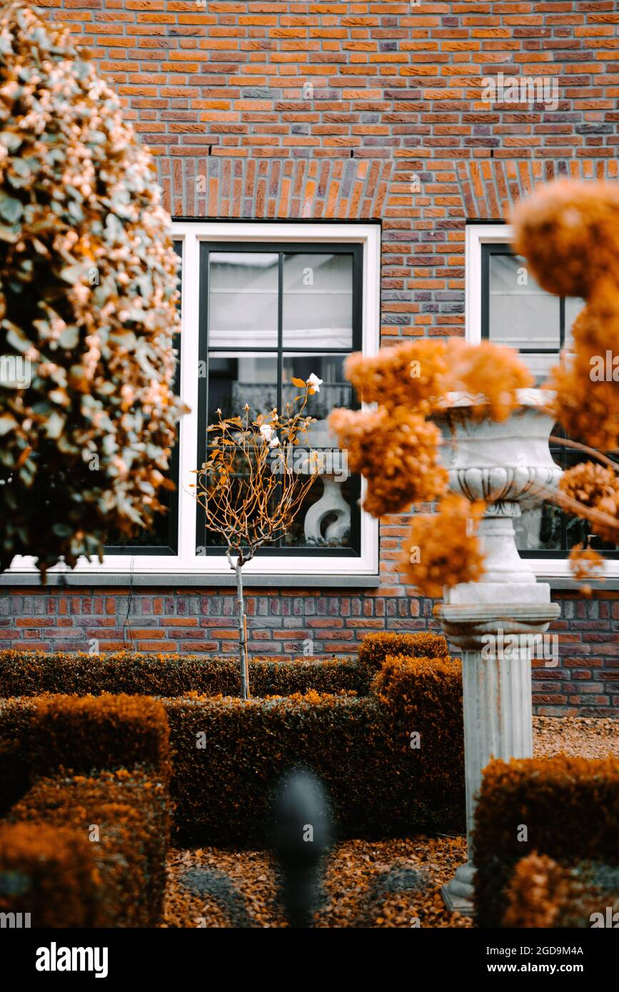 Vertical shot of a landscape with a brick building background in ...