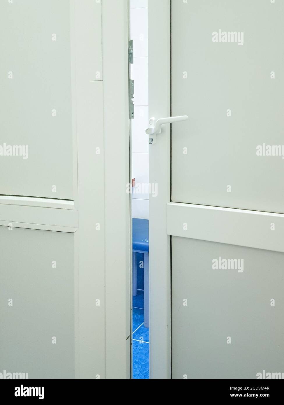 A slightly open door to a medical laboratory or a doctor's office, a ...