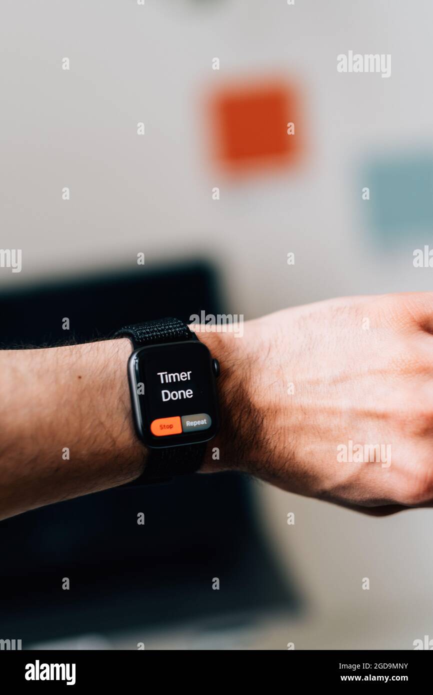 Male hand wearing a smartwatch with 'timer done' on its screen Stock ...