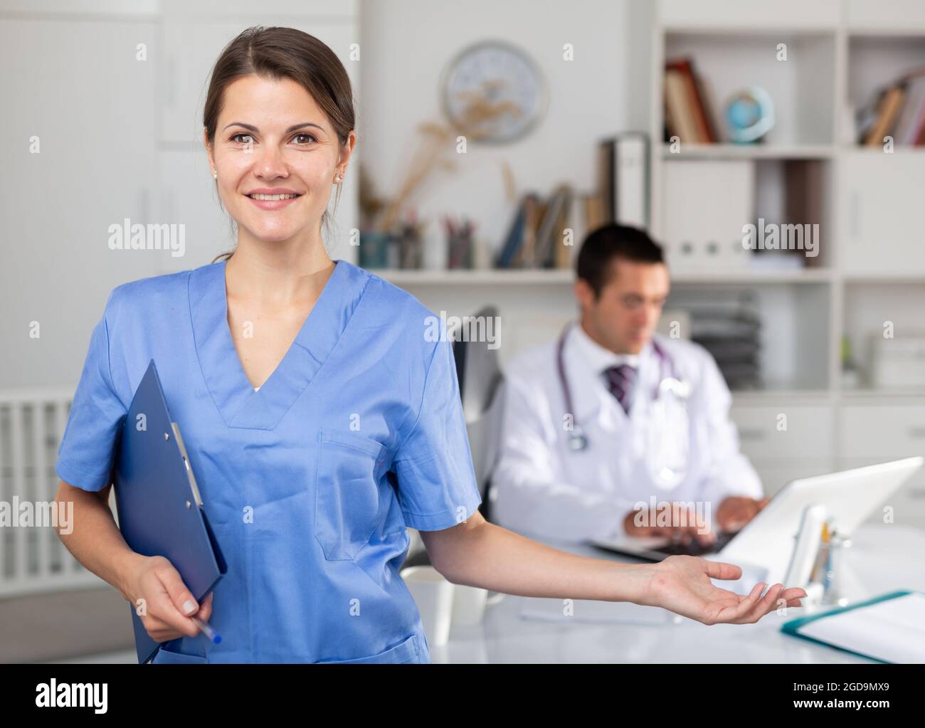 Female doctor making welcome gesture, politely inviting patient in ...