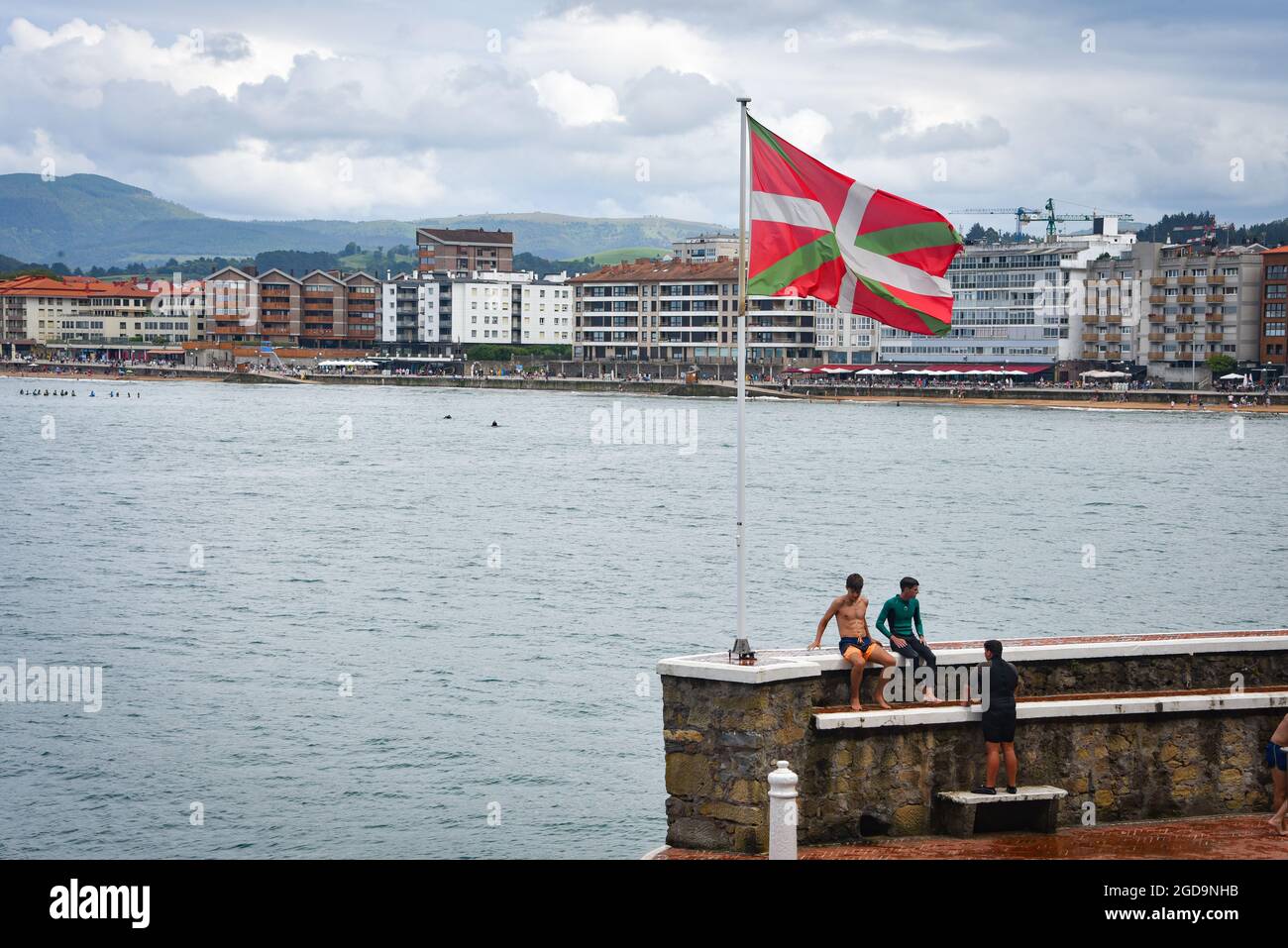 Zarautz, Spain - July 25, 2021: Local teens jump into the sea from the ...