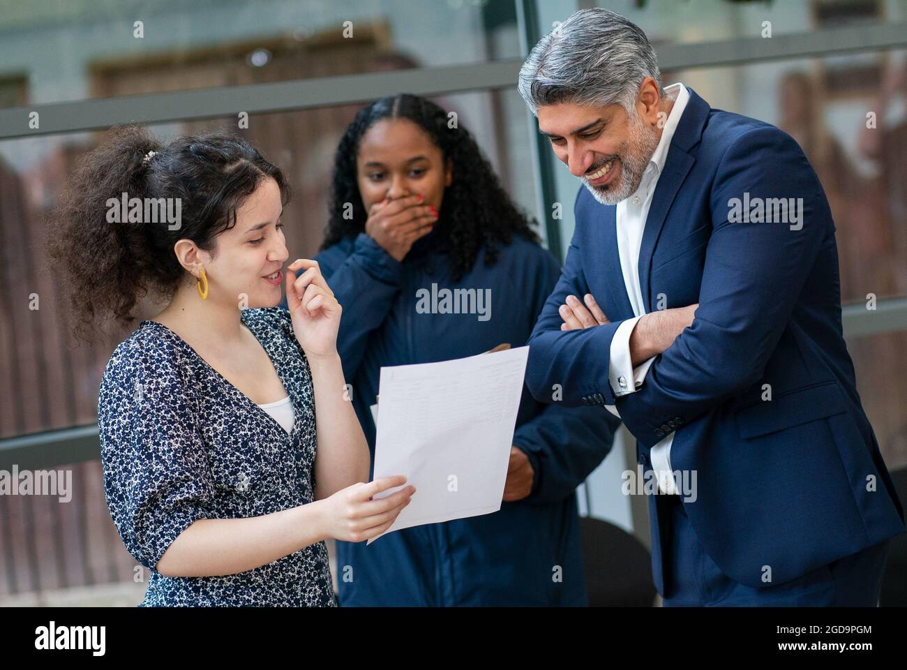Sarah Aly (left) adn Jaida Richards (centre) open their GCSE results alongside Principal Paul ...