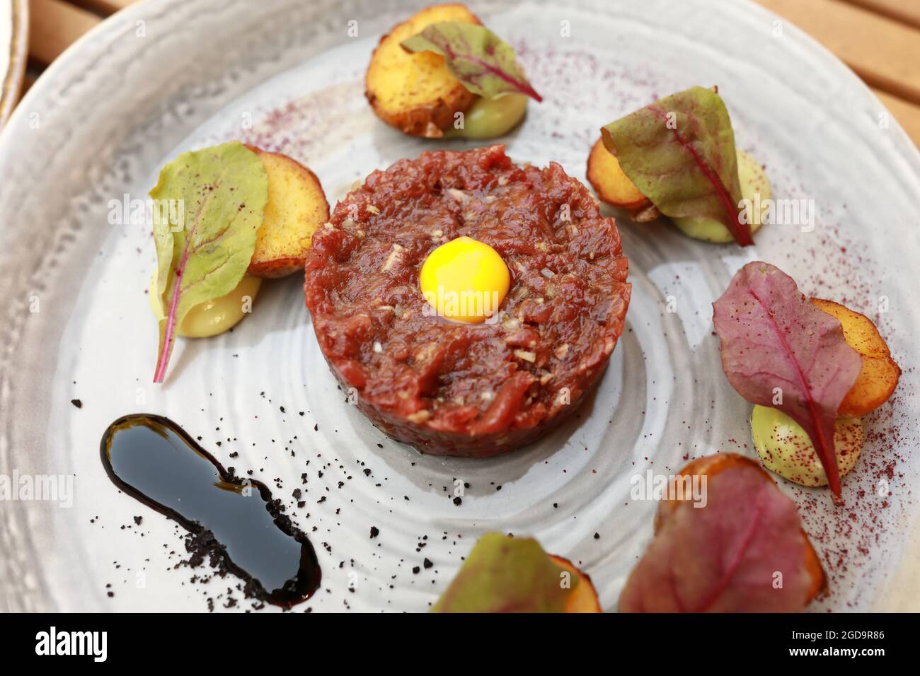 Beef steak tartare with quail egg in restaurant Stock Photo - Alamy