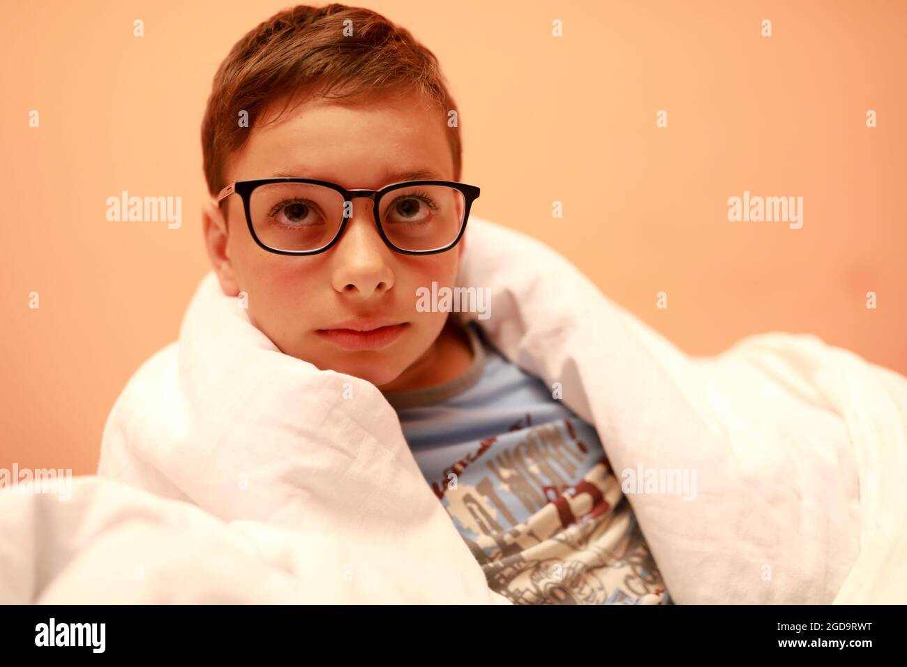 Portrait of serious child with glasses at home Stock Photo - Alamy