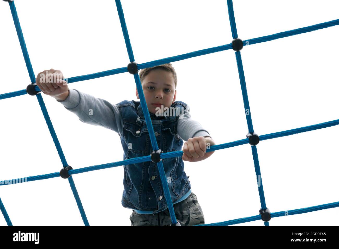 Child climbing on net on outdoor playground Stock Photo - Alamy