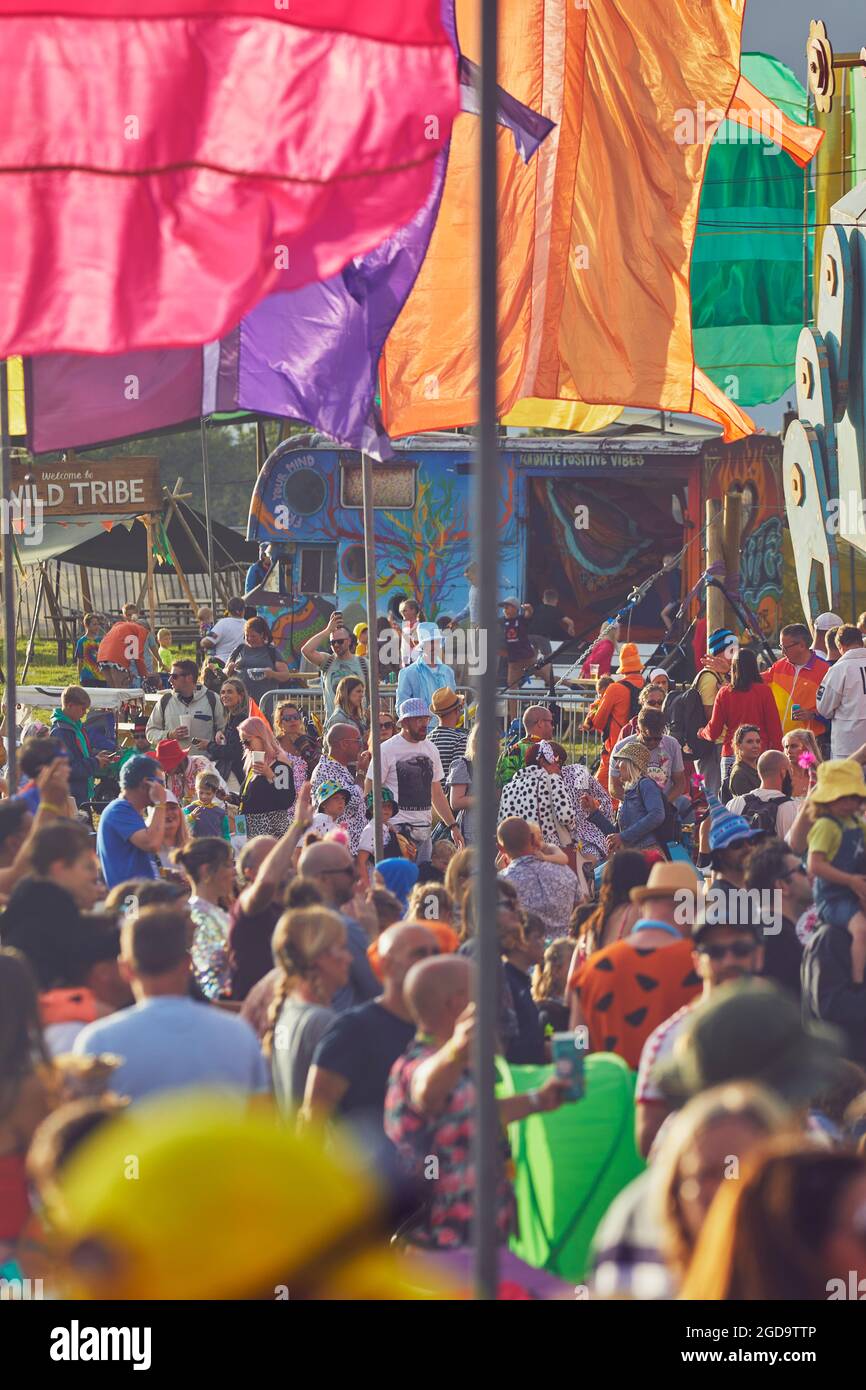 Flags and crowds of festival-goers at a summer music festival. Camp ...