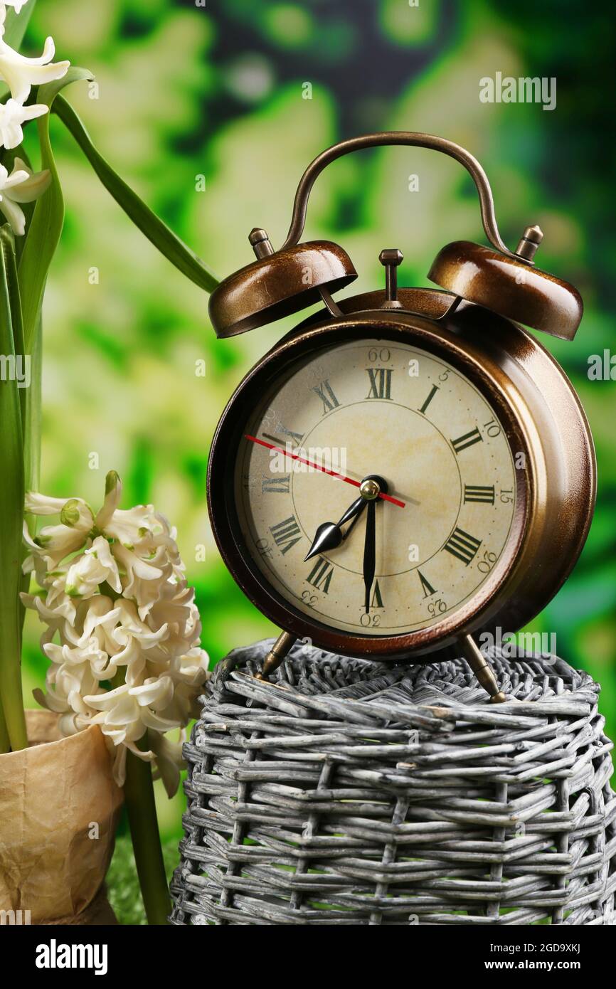 Alarm clock on nature background Stock Photo - Alamy