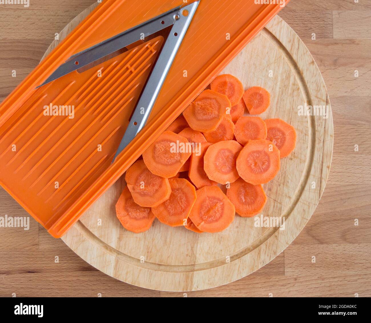 Raw carrots are cut with special cutting into small circles Stock Photo ...