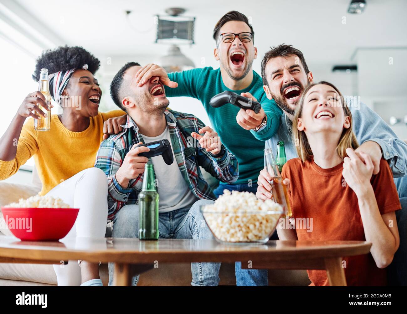 friend beer party video games gaming joystick happy Stock Photo - Alamy