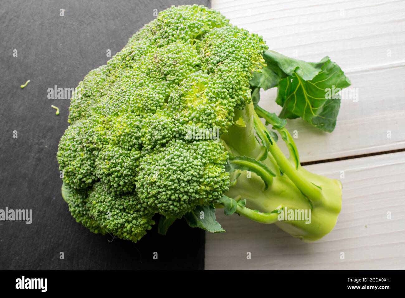 Fresh organic green broccoli with a slate board, close-up, on a white ...