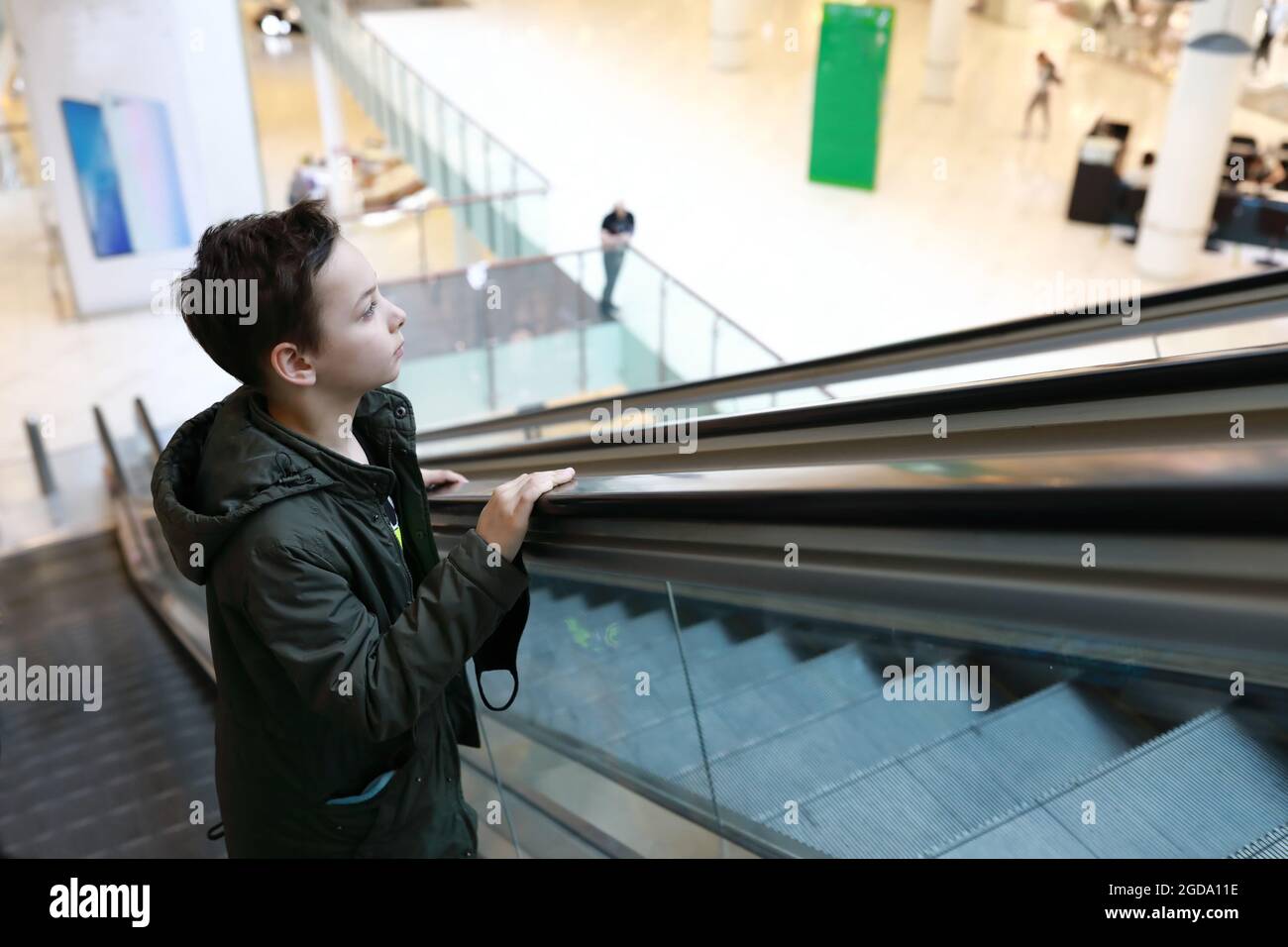 Portrait of child on escalator in mall Stock Photo - Alamy
