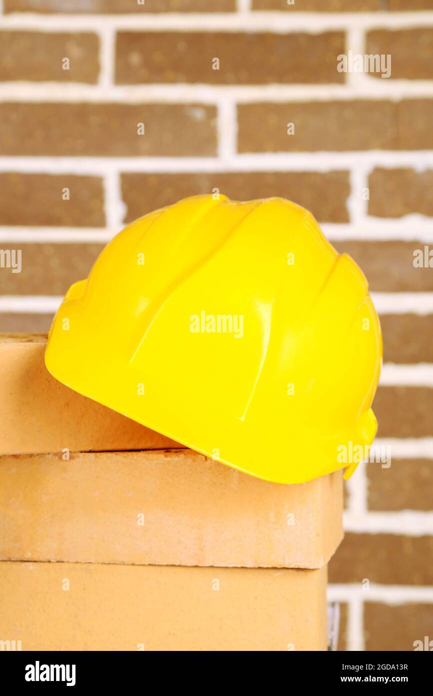 New bricks and building tools on brick wall background Stock Photo - Alamy