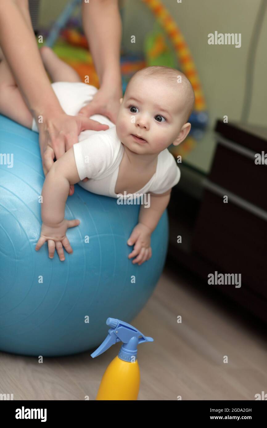 The baby training on a gymnastic ball at home Stock Photo - Alamy