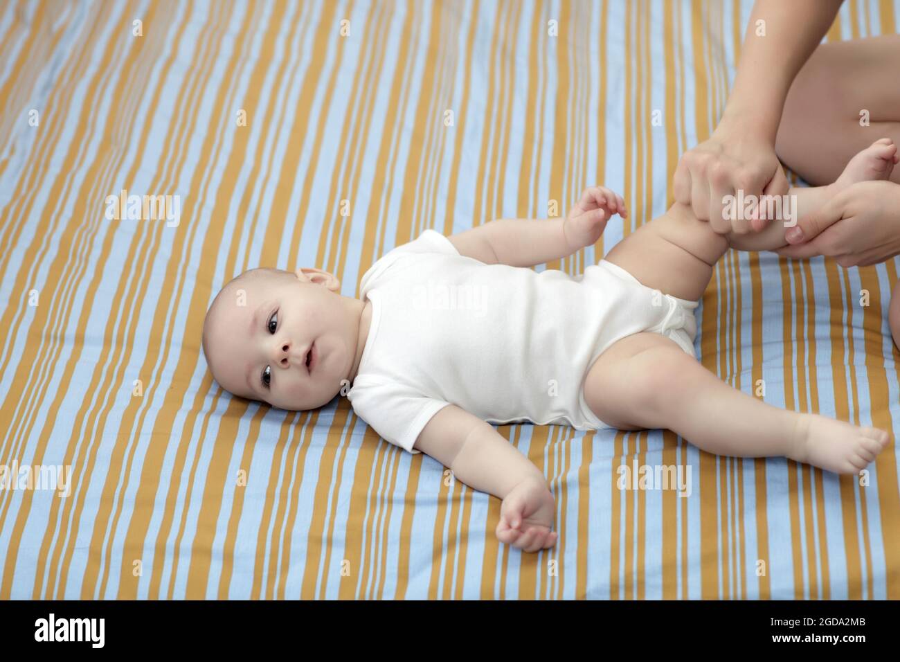 The massage of baby leg at home Stock Photo - Alamy