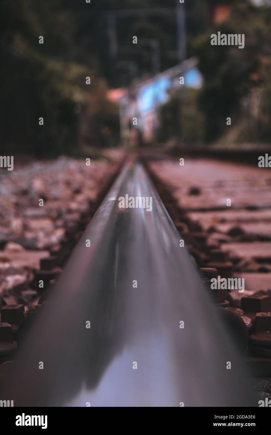 Selective focus shot of a railway track below the steep mountain Stock ...
