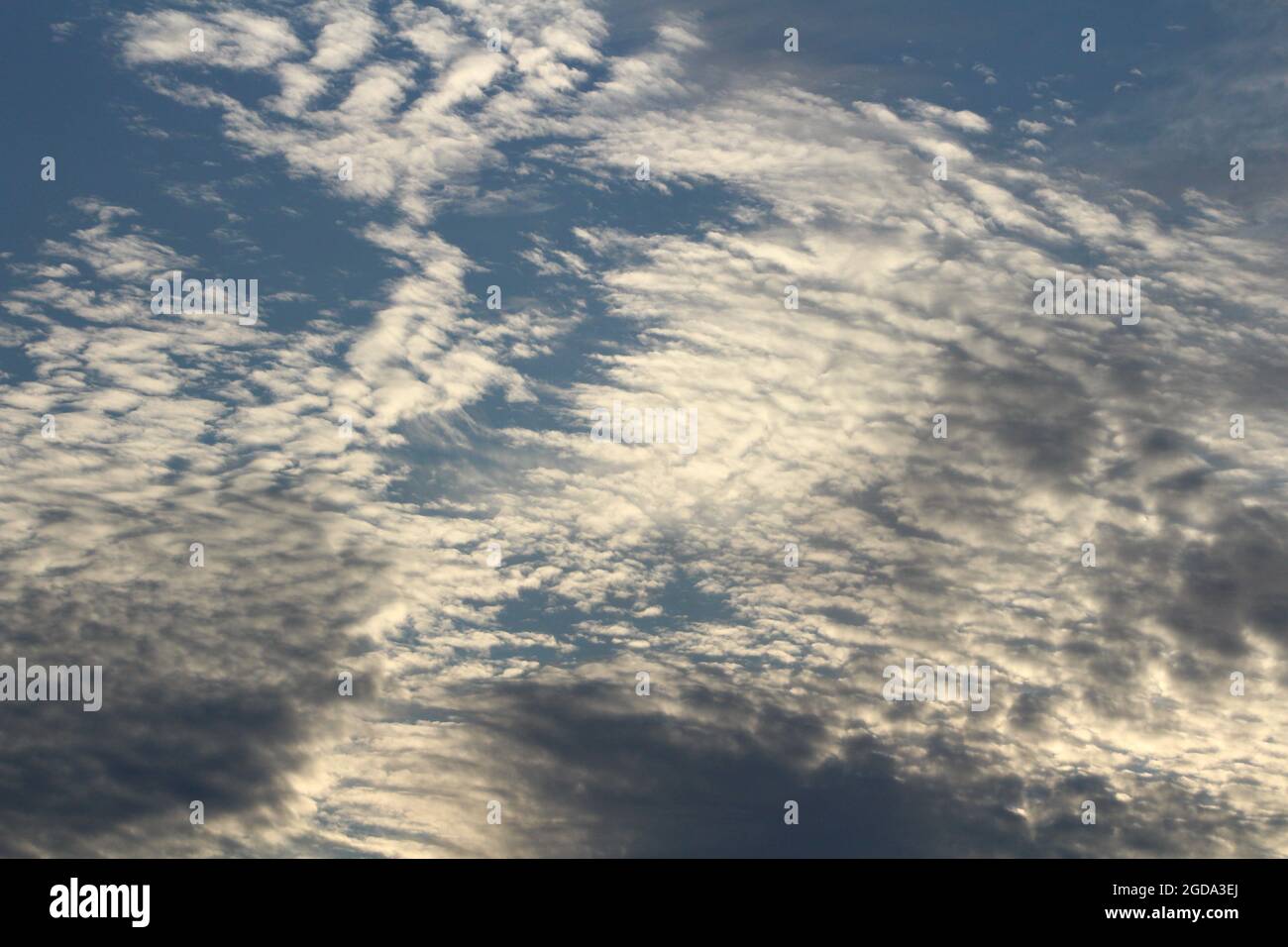 Dusky cloudscape in the blue sky during sunrise Stock Photo - Alamy