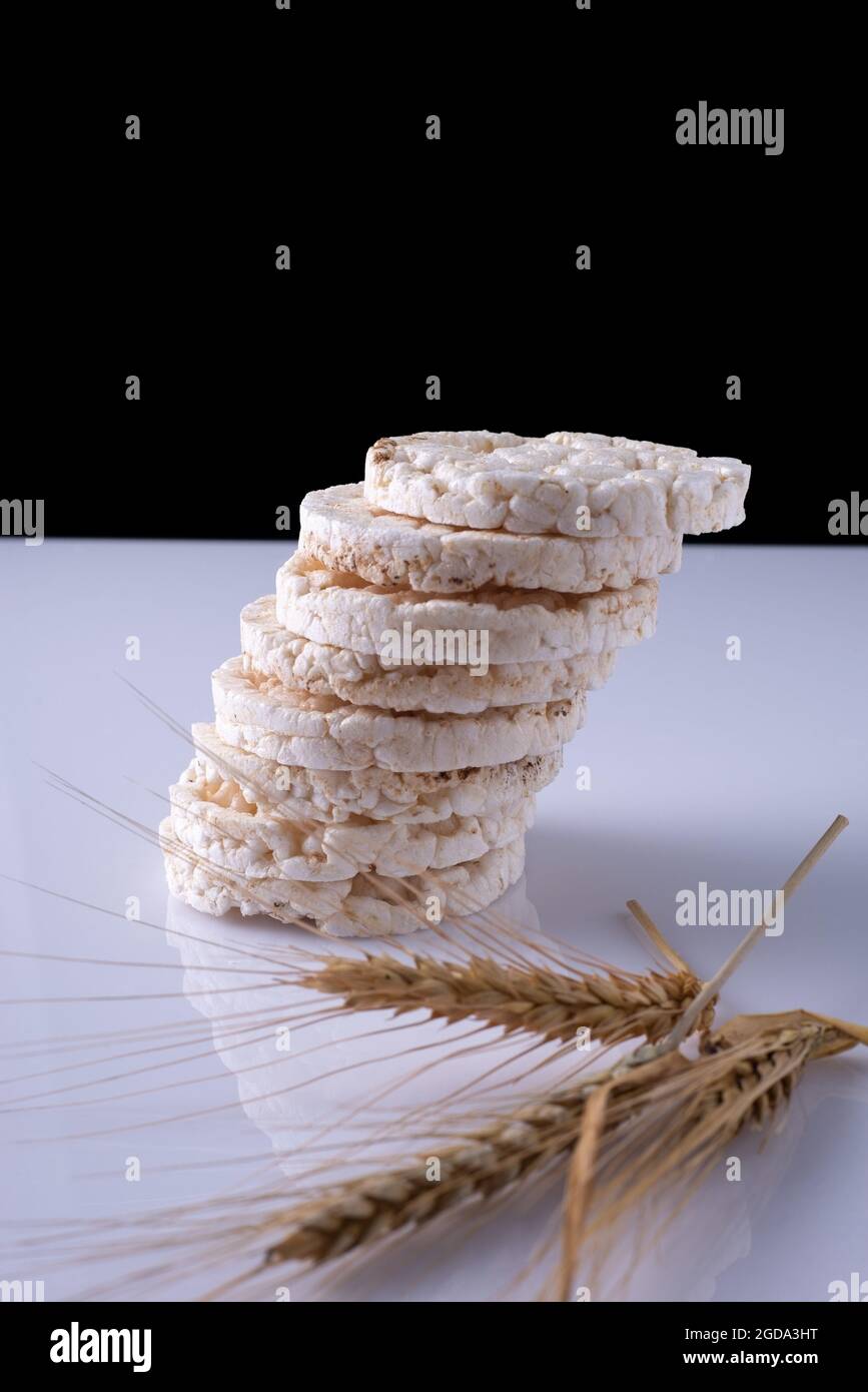 rice cakes with wheat ears on white table and black background Stock ...