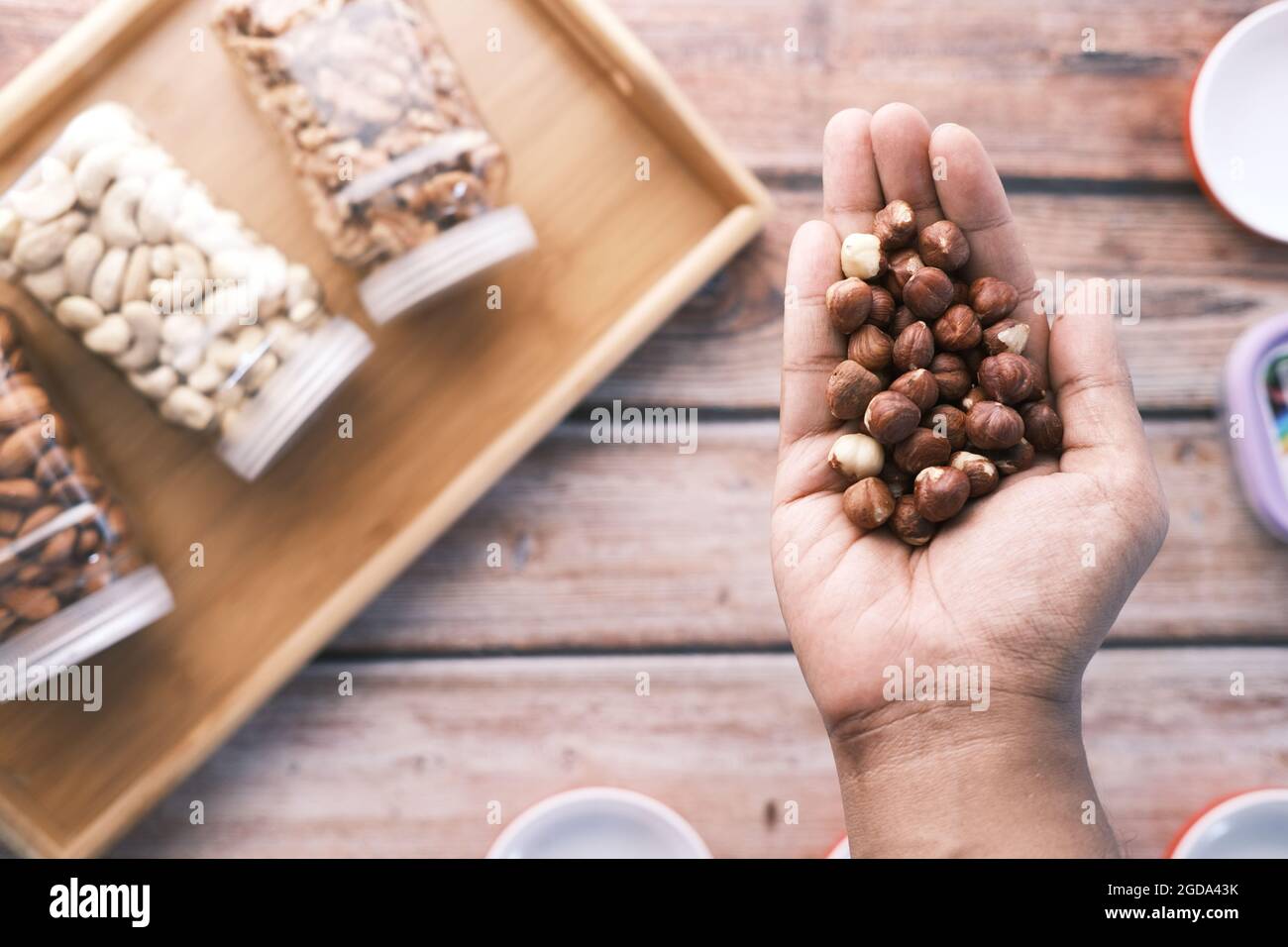 top view of hazelnuts on palm of hand Stock Photo - Alamy