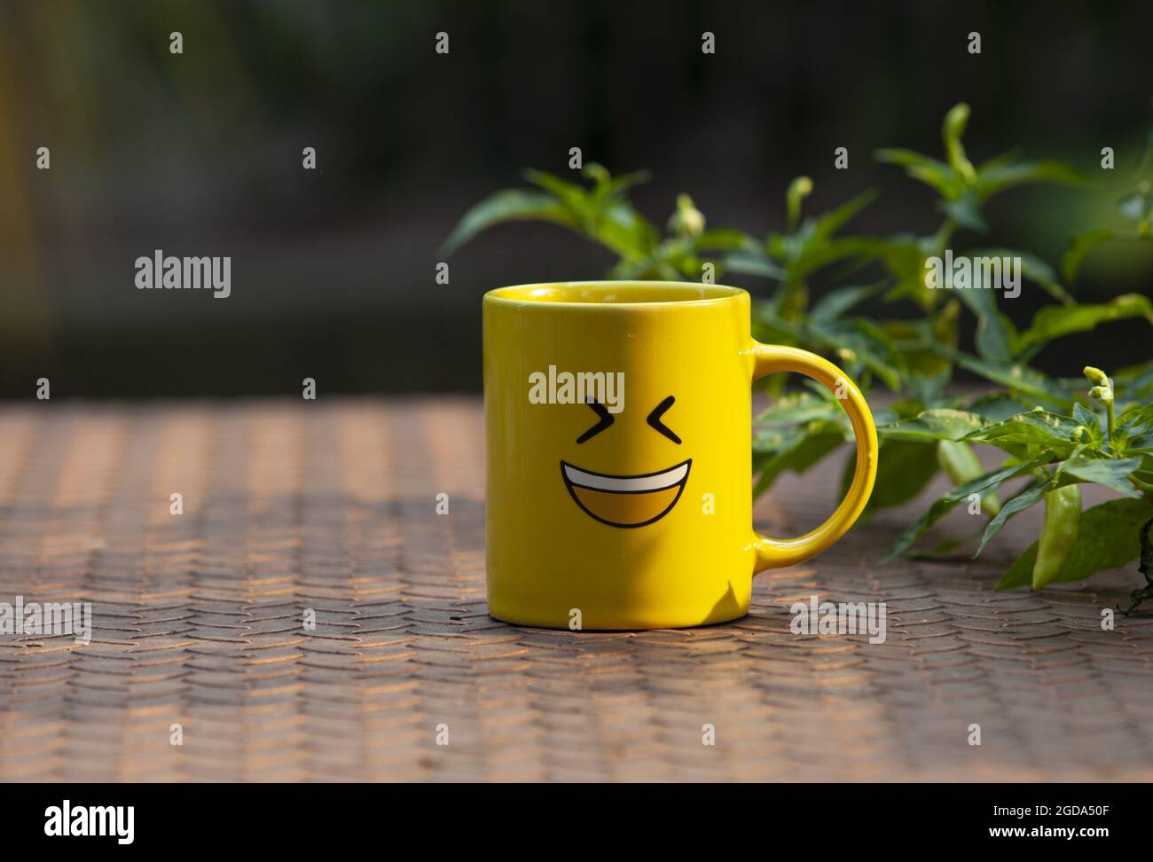 Yellow glass with smiling emoticon Stock Photo - Alamy
