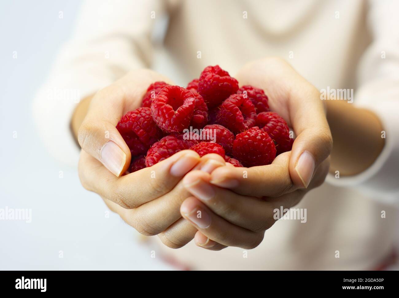a handful of raspberry Stock Photo - Alamy