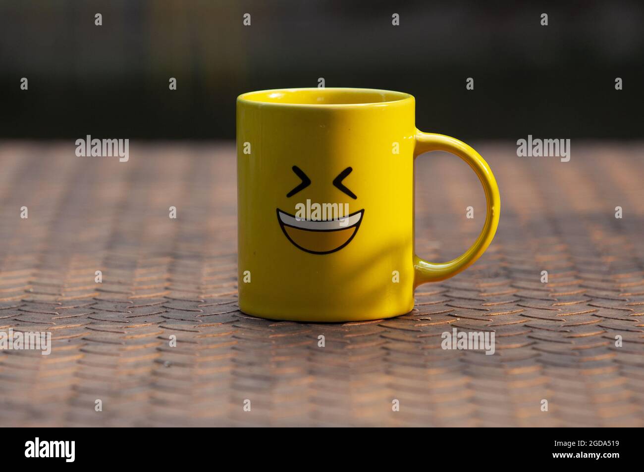 Yellow glass with smiling emoticon Stock Photo - Alamy