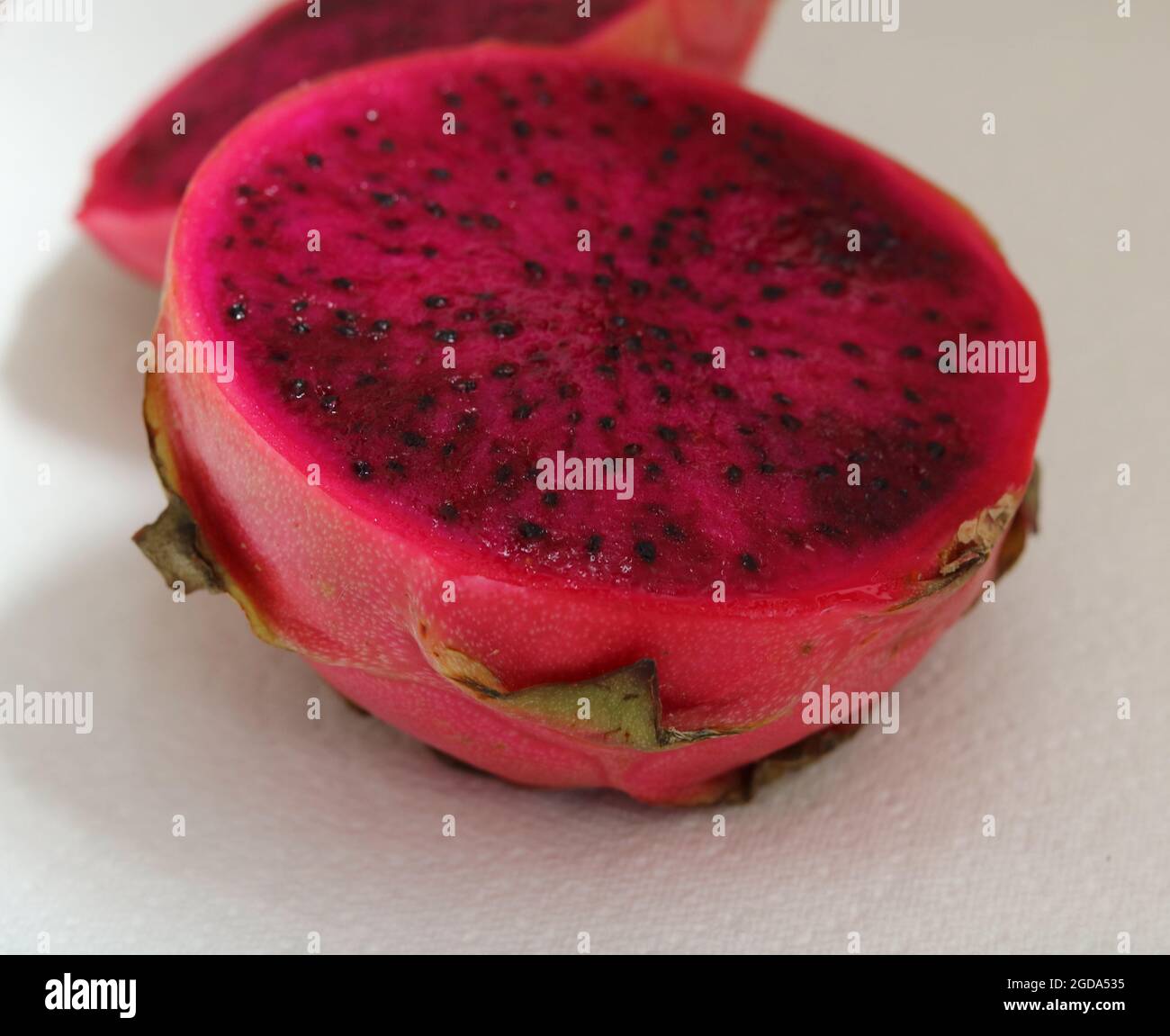 Close up of section through juicy dark pink pitaya fruit Stock Photo ...