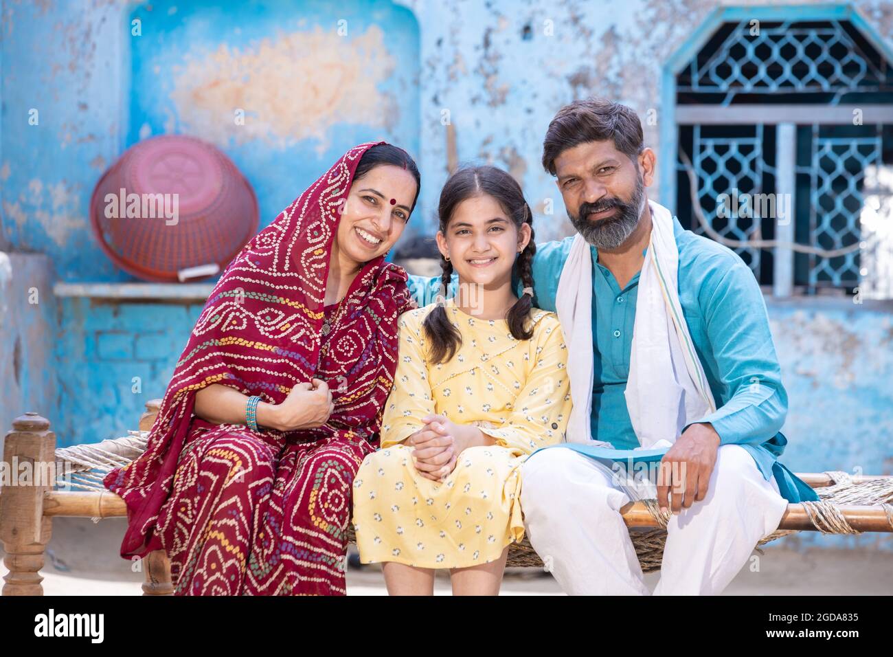 Portrait of happy rural indian family looking at camera while sitting ...