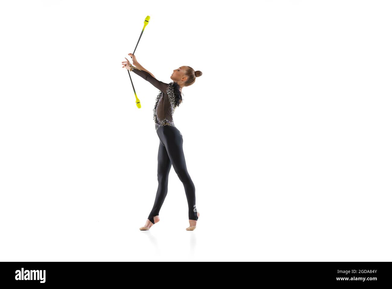 One Caucasian girl, rhythmic gymnastics artist practicing with baton ...