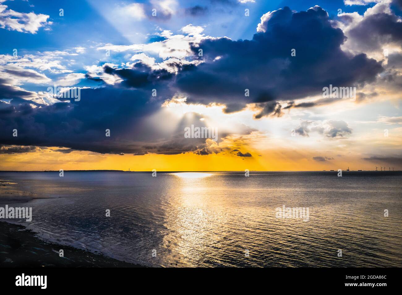 Sun setting over the ocean at Herne Bay Stock Photo - Alamy