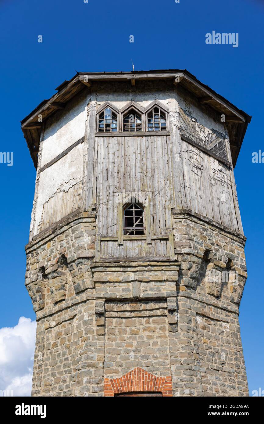 The upper part of an ancient watchtower made of stone blocks and wood ...