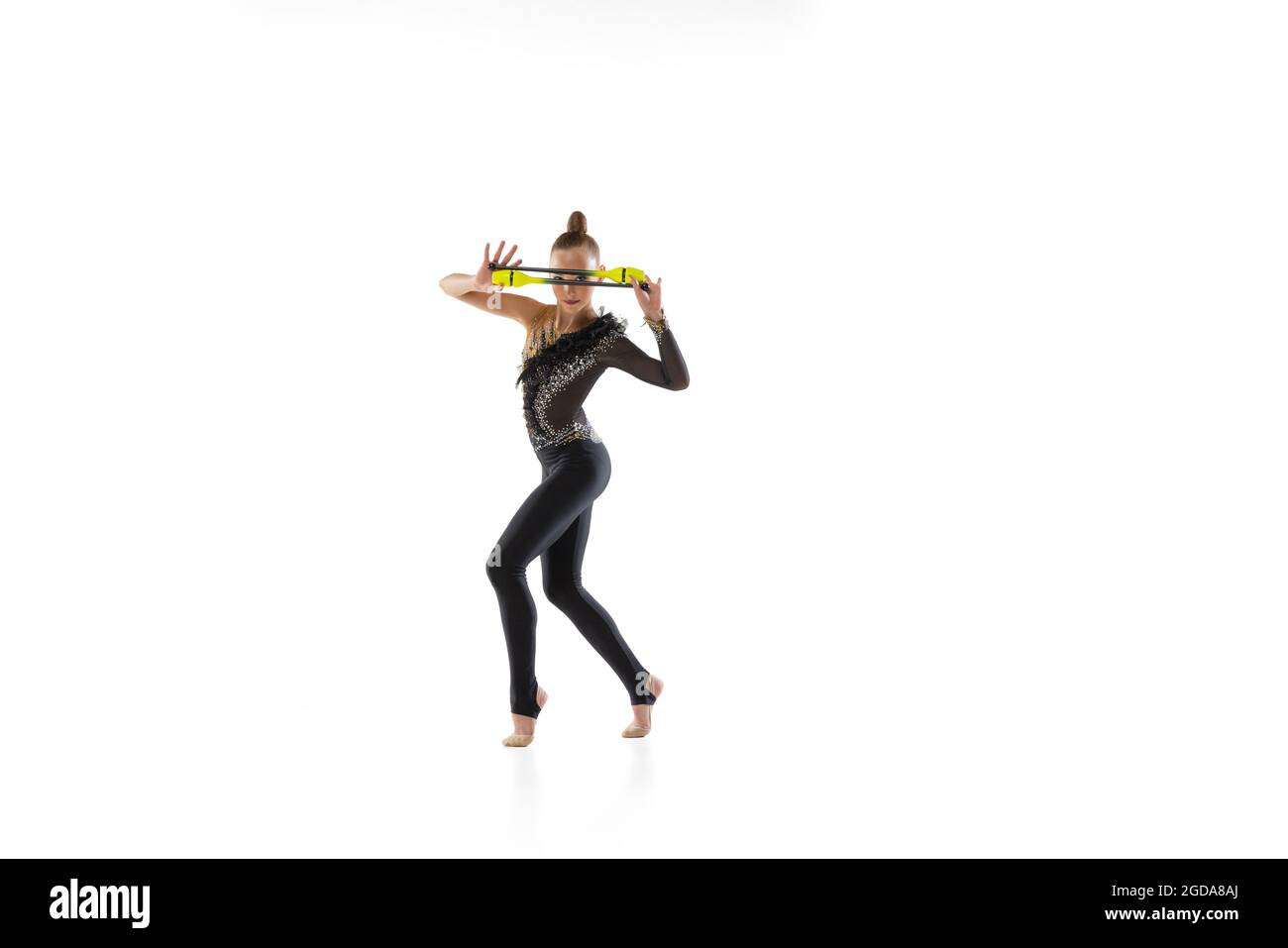 One Caucasian girl, rhythmic gymnastics artist practicing with baton ...