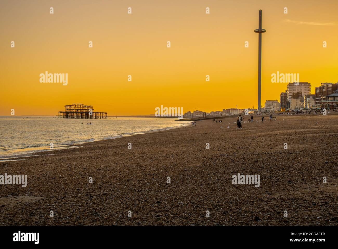 Beautiful view of a beach with buildings at sunset Stock Photo - Alamy