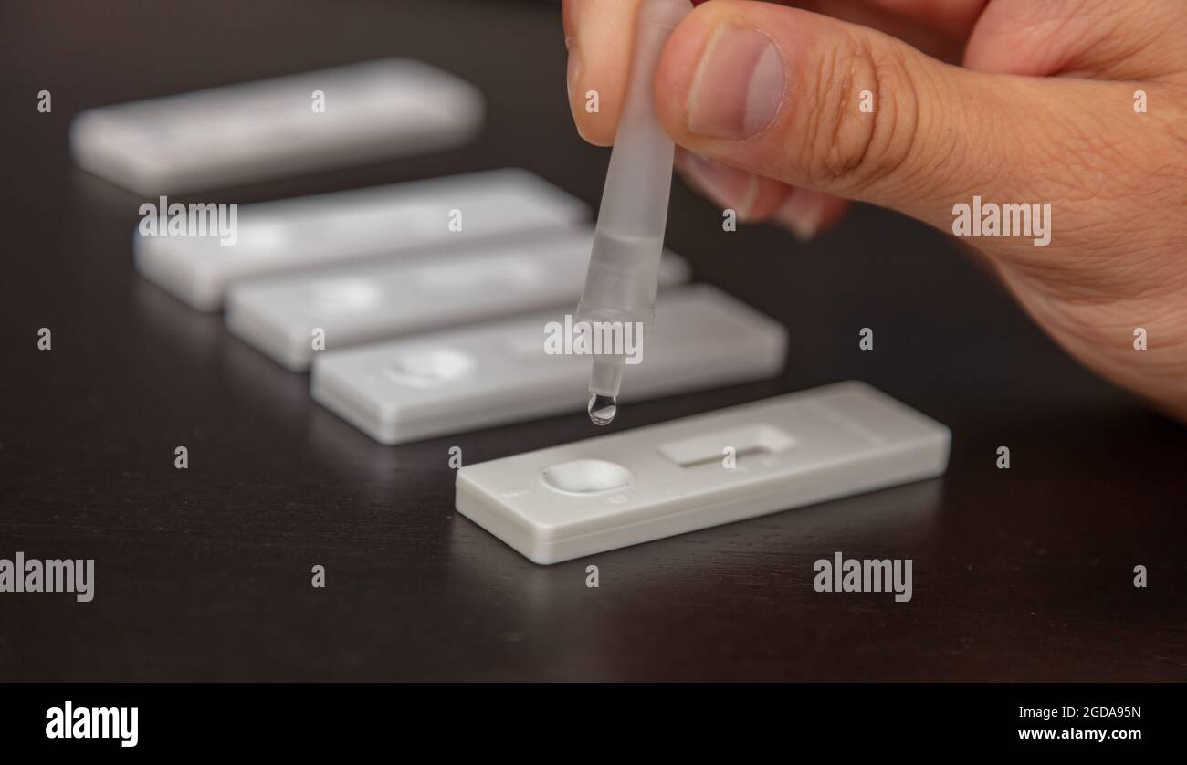 Rapid antigen diagnostic test kit, tube dropping sample on device ...