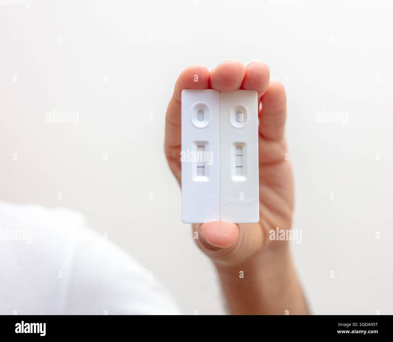 Man hand with covid 19 positive and negative result rapid tests, kits ...