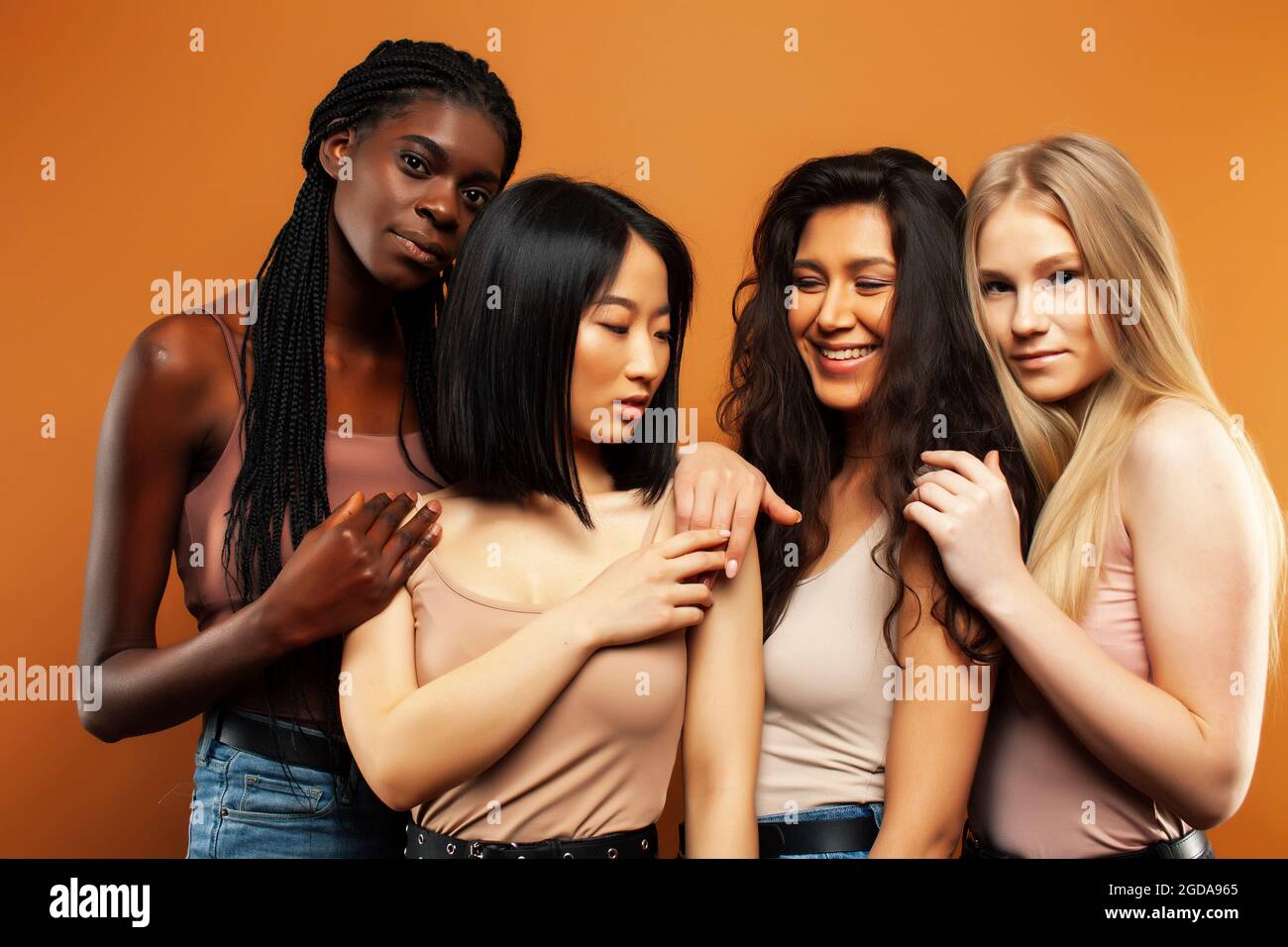 young pretty caucasian, afro, scandinavian woman posing cheerful together on brown background ...