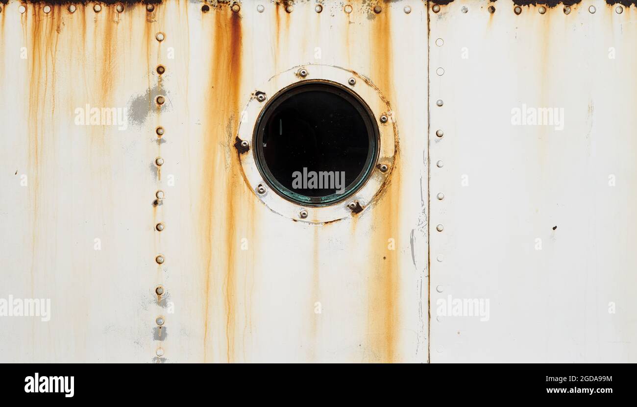 Porthole on the side of a rusty boat Stock Photo - Alamy