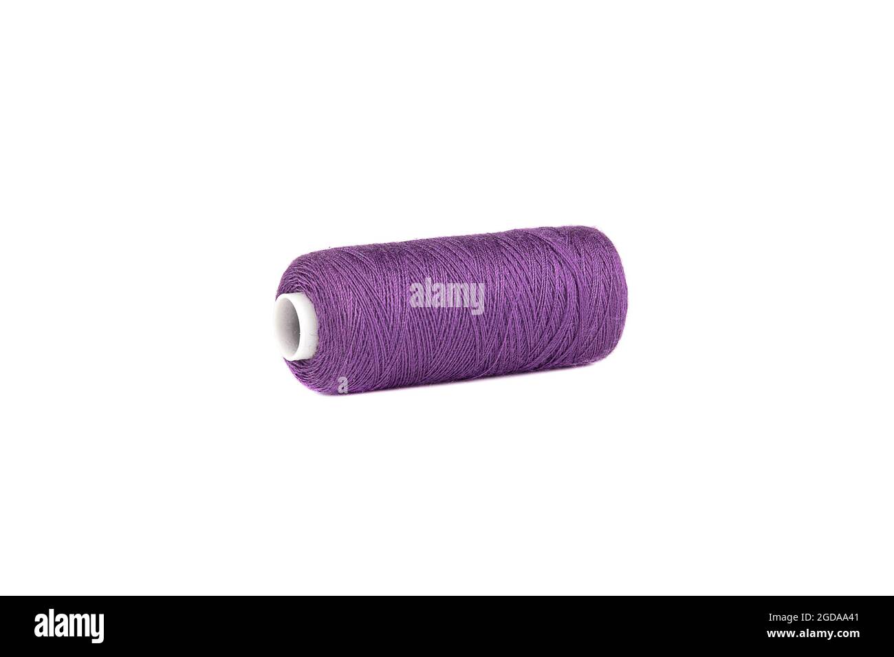 Spool of purple threads lies on a white background. Copy space Stock ...
