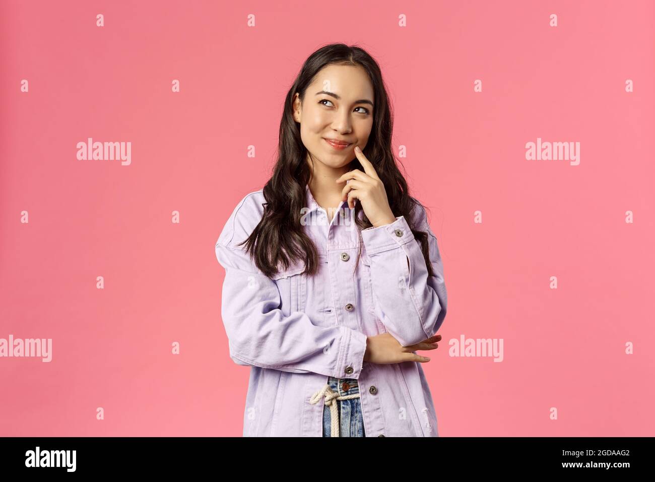 Hmm interesting. Portrait of smiling creative girl in denim jacket ...