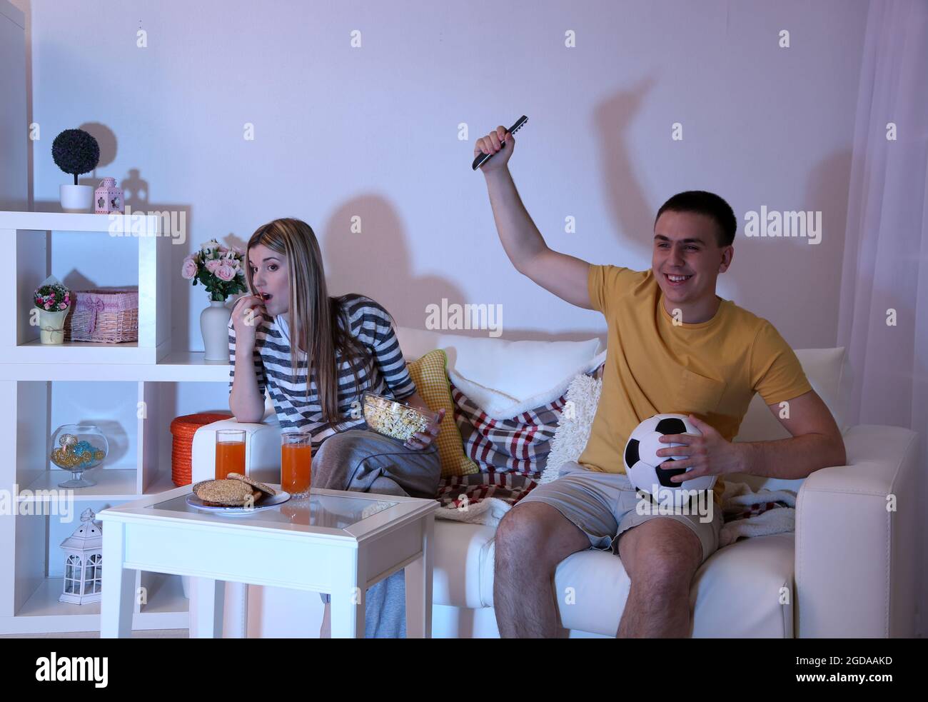 Young couple watching television at home of blacking-out Stock Photo ...