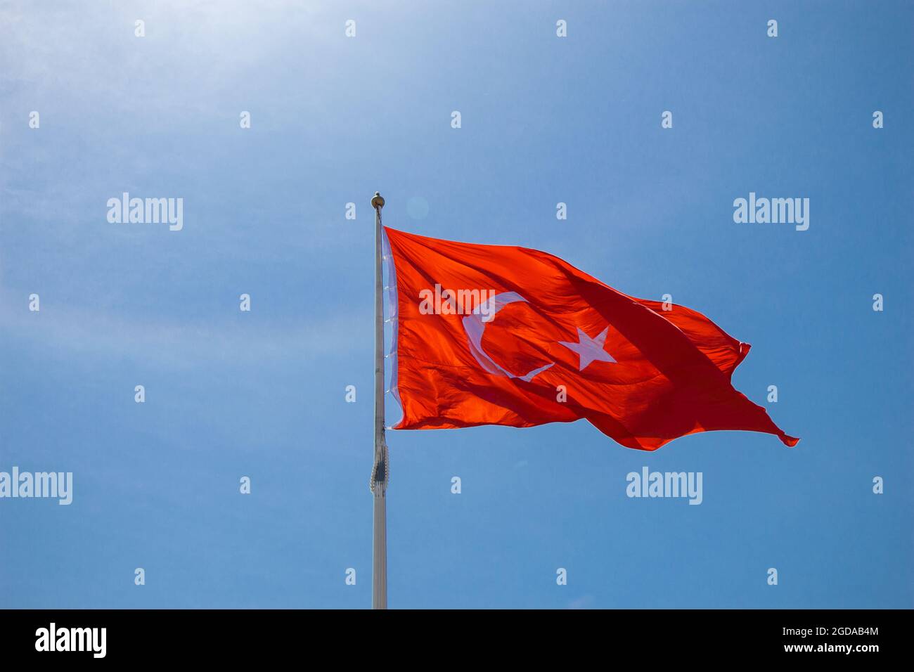 Turkish national flag with white star and moon on a pole in sky Stock ...