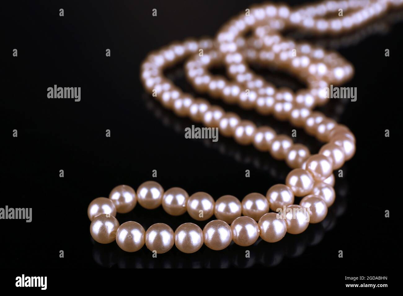 Beautiful pearls on black background Stock Photo - Alamy