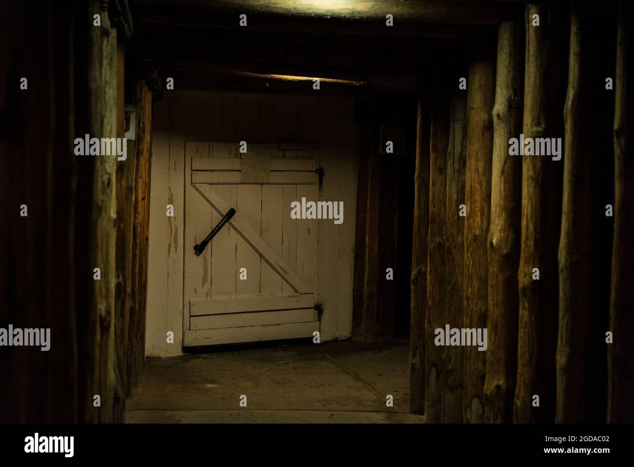 Old corridor propped up with wooden beams and a closed door in the ...