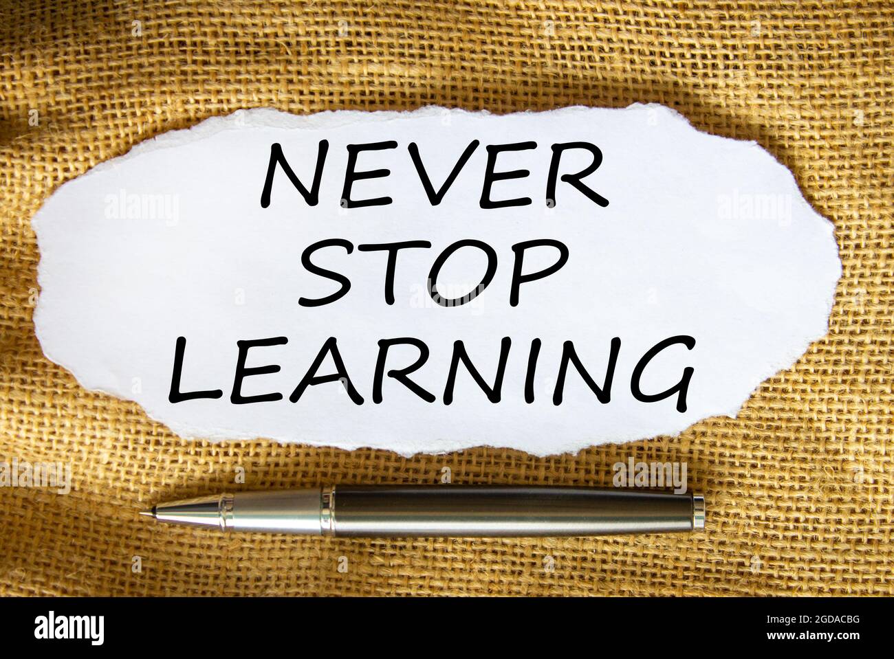 Never stop learning symbol. Words 'Never stop learning' on white paper ...