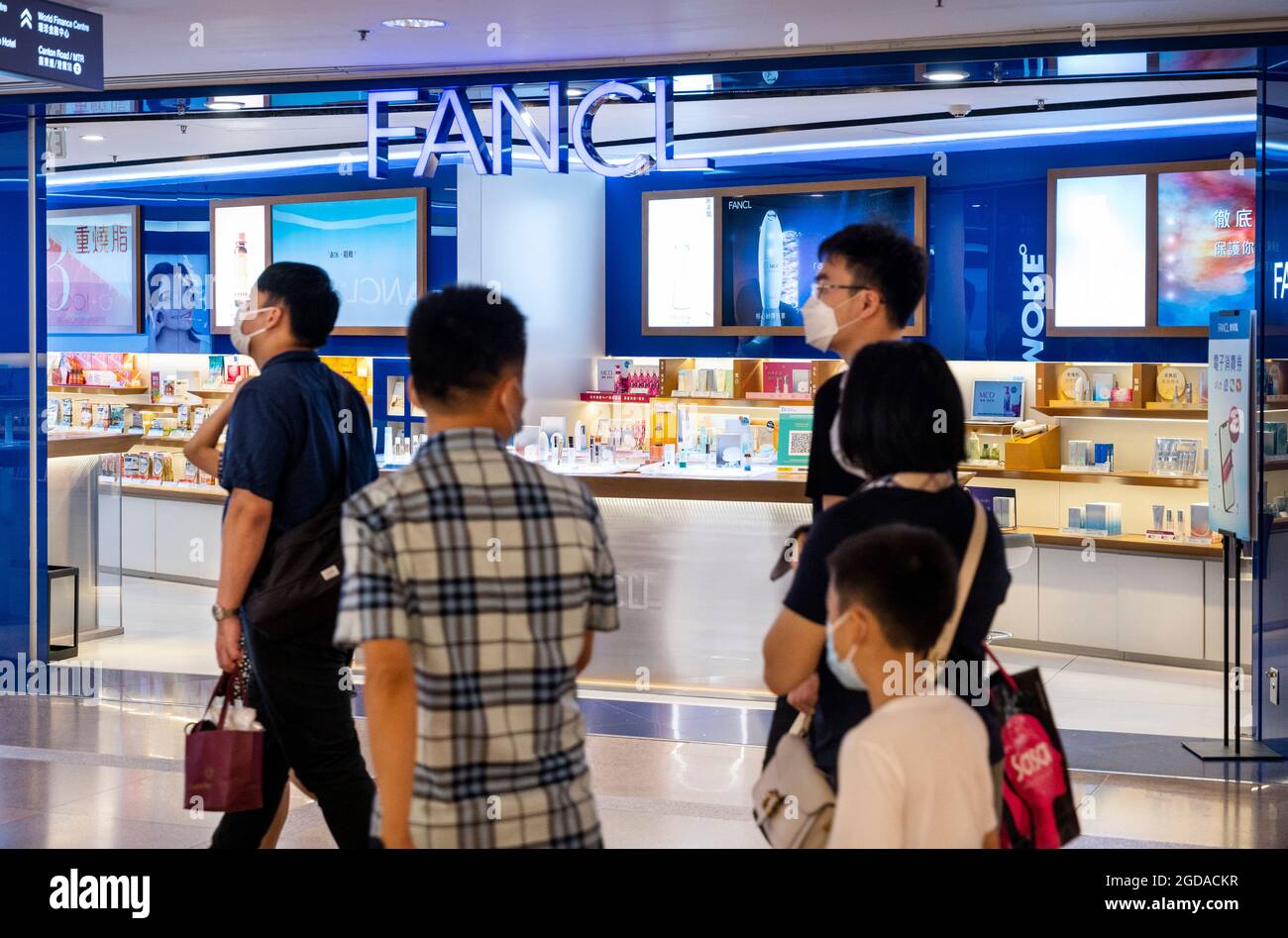 Shoppers walk past the Japanese cosmetics and dietary supplements ...