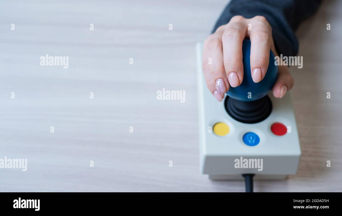 Woman with cerebral palsy works on a specialized computer mouse Stock ...