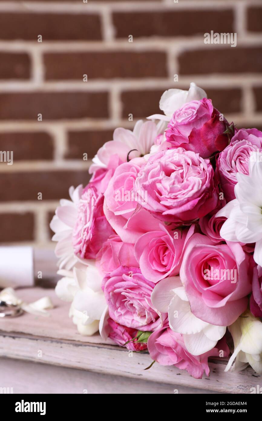 Beautiful wedding bouquet on bricks wall background Stock Photo - Alamy