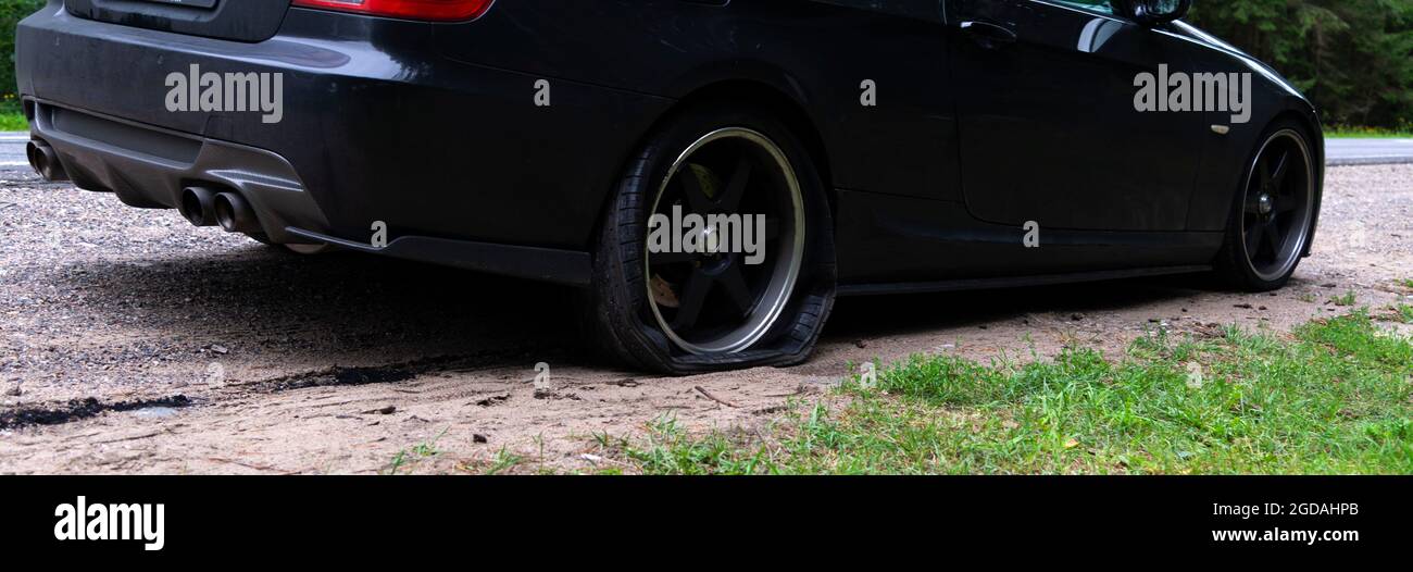 Punctured wheel of a modern car on the road. Car tire puncture Stock ...