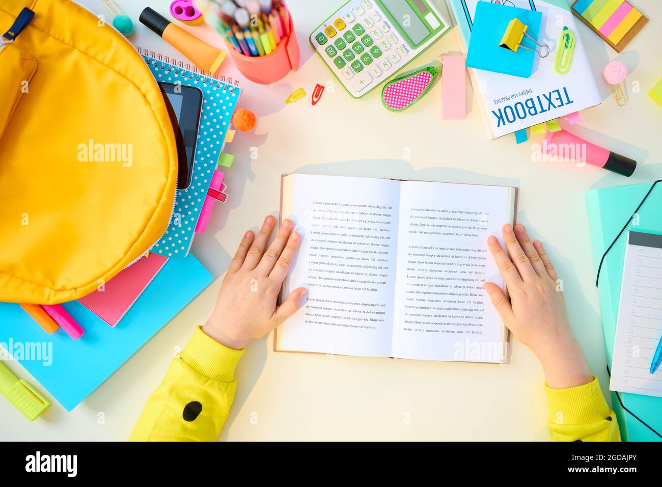 Back to school. Upper view of modern pupil with open book, workbooks ...