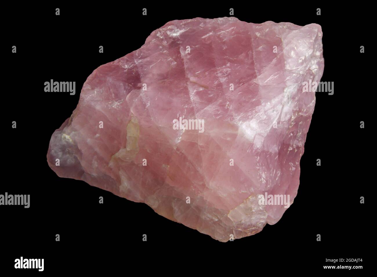 unpolished rose quartz specimen isolated on a black background Stock ...